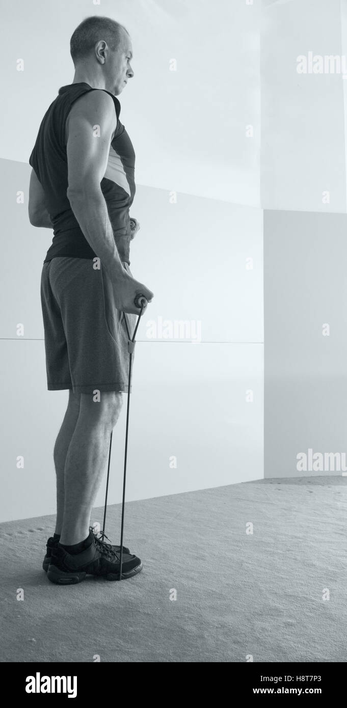 Performing exercises with resistance rope fitness Stock Photo - Alamy