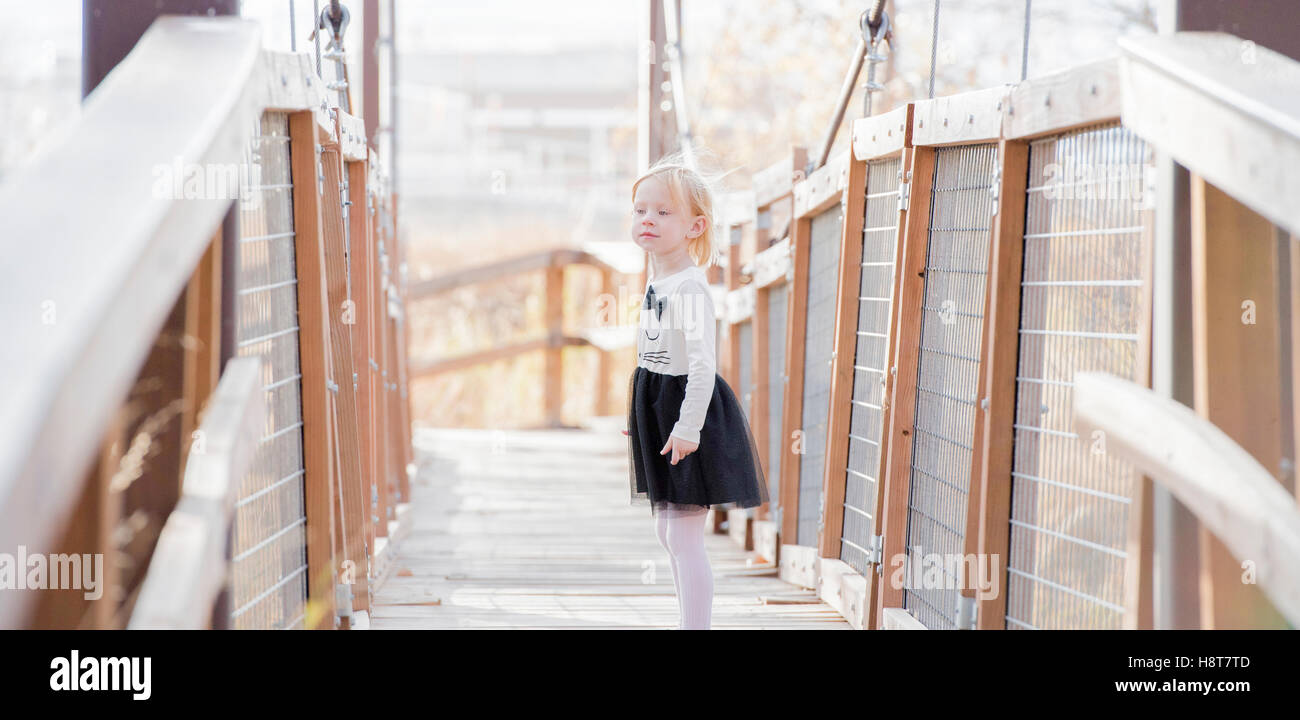 Little Girl Stands on a Suspension Bridge Stock Photo - Alamy