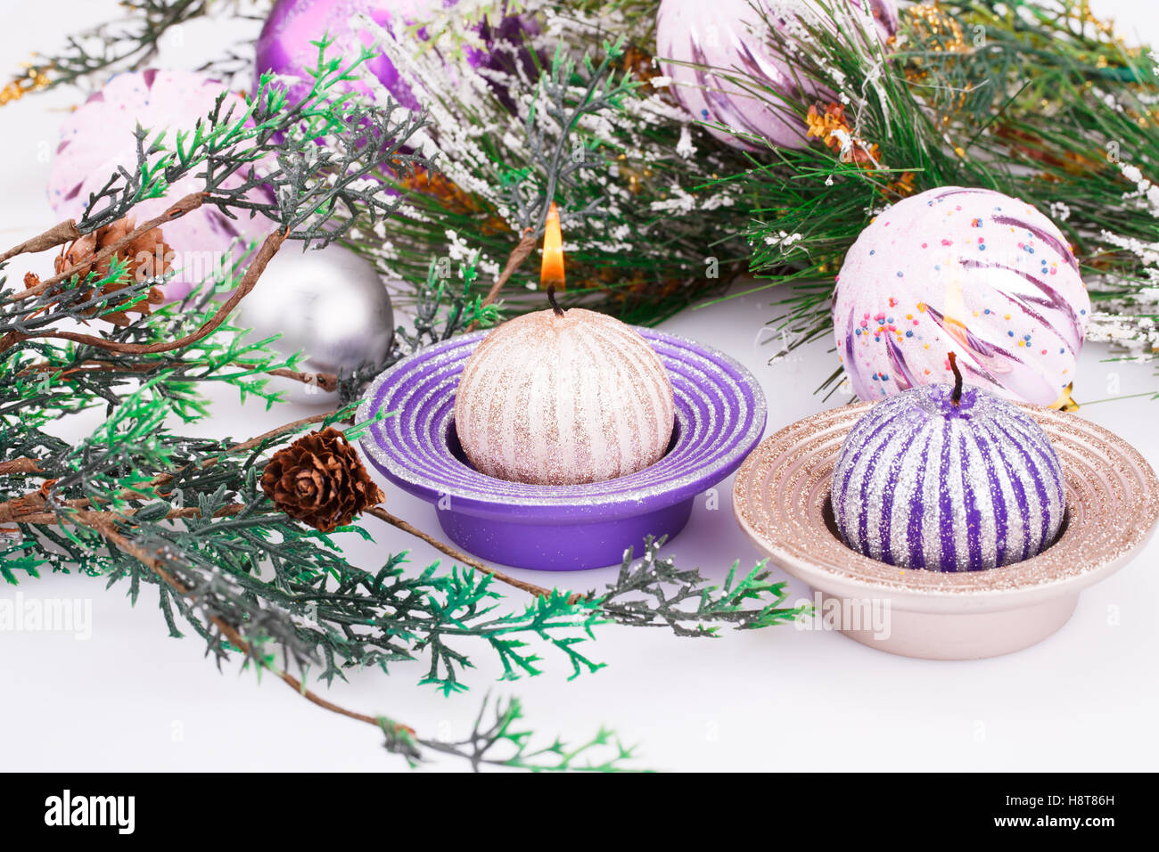 Christmas pink balls, candles and fir tree on gray background Stock ...