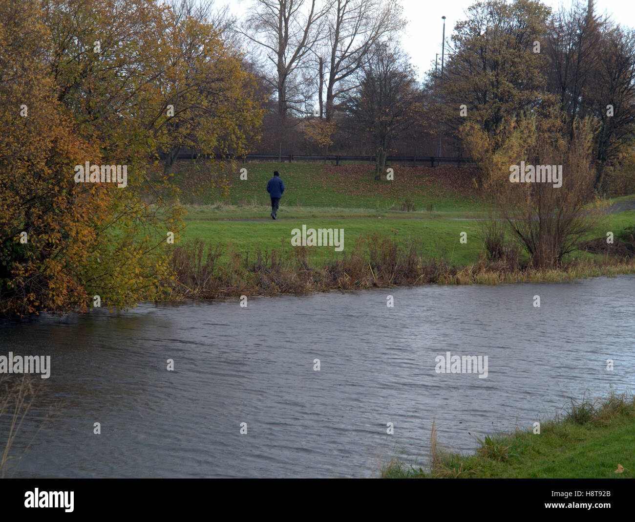 lonely man alone on a tow path walking Stock Photo - Alamy