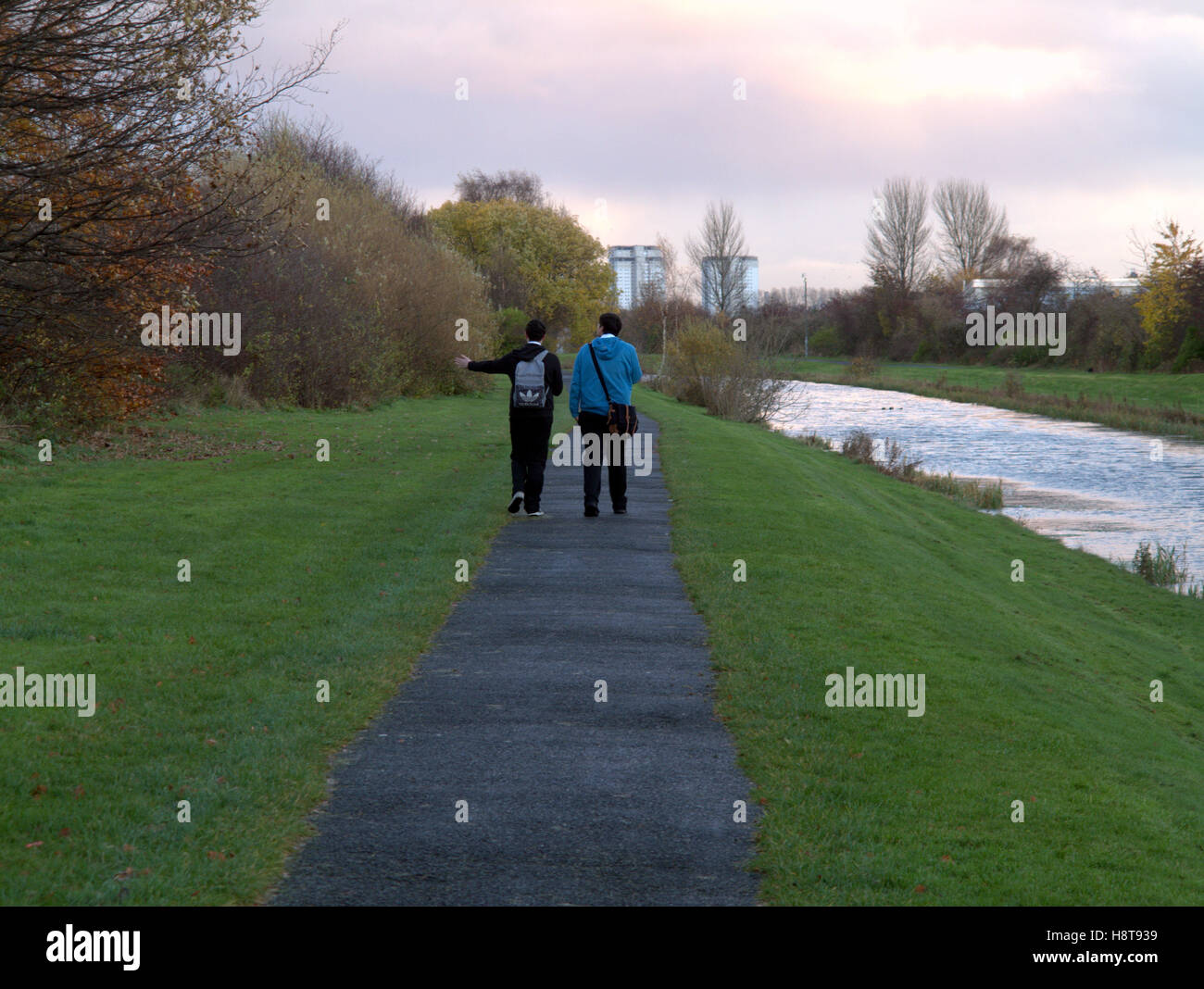 two boys schoolchildren on a tow path walking Stock Photo - Alamy