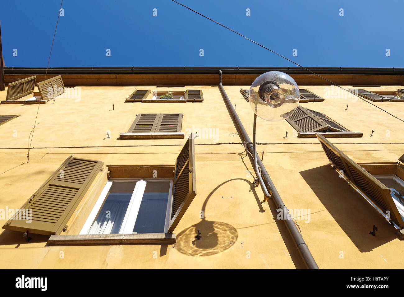 street lamp from the bottom with background the facade of the building ...