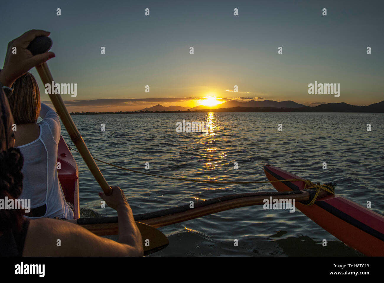 Paddling at sunset Stock Photo - Alamy