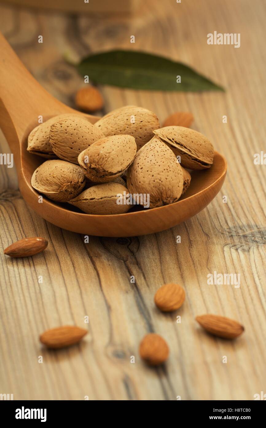 Almonds on brown wooden background. Beneficials for the brain Stock ...