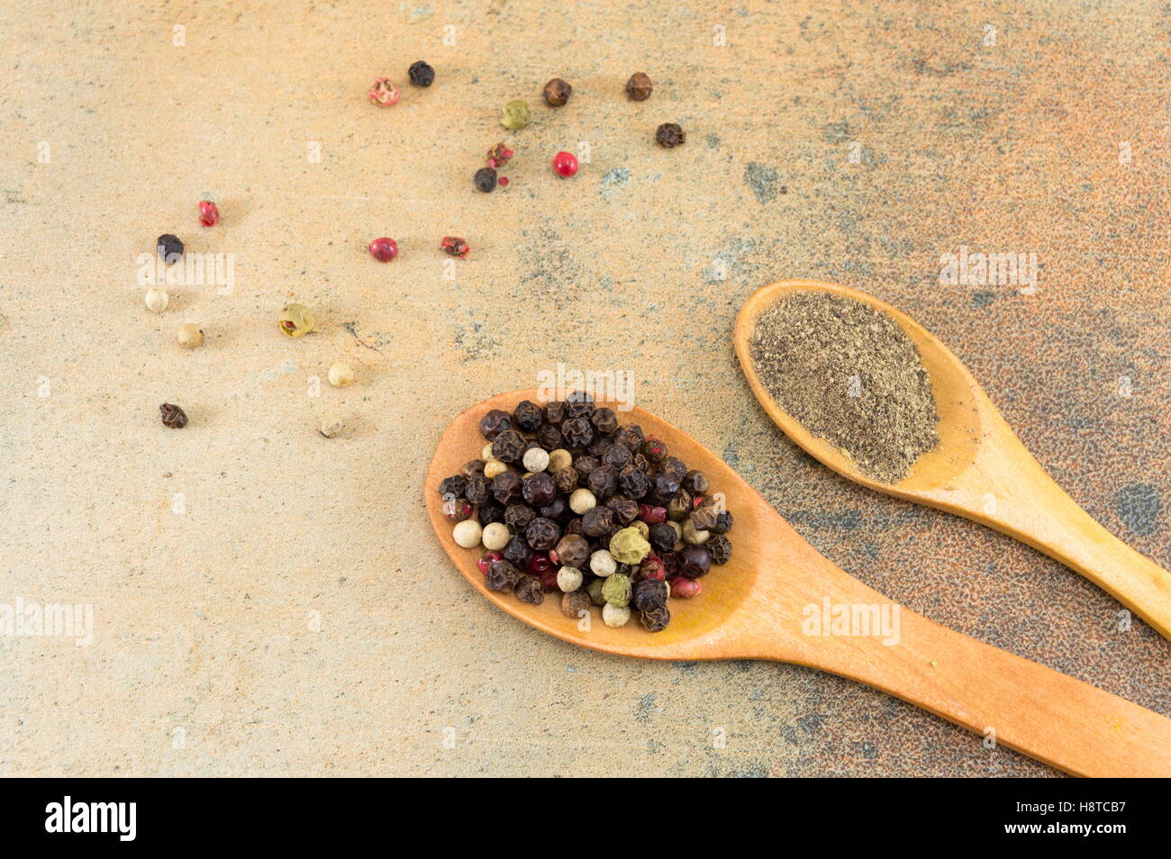 red and brown pepper balls and powder on stone table Stock Photo - Alamy