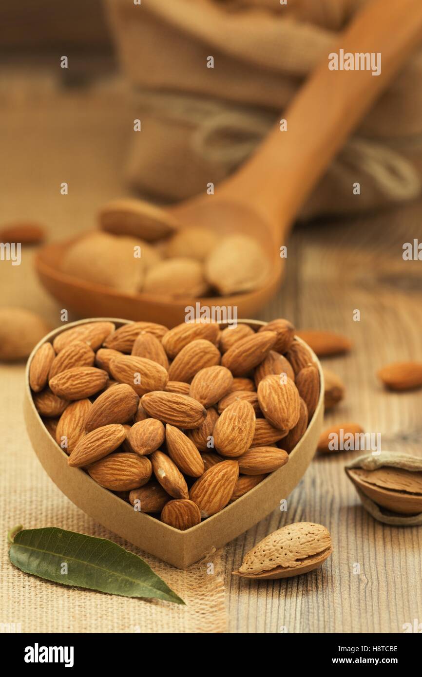Almonds on brown wooden background. Beneficials for the brain Stock ...