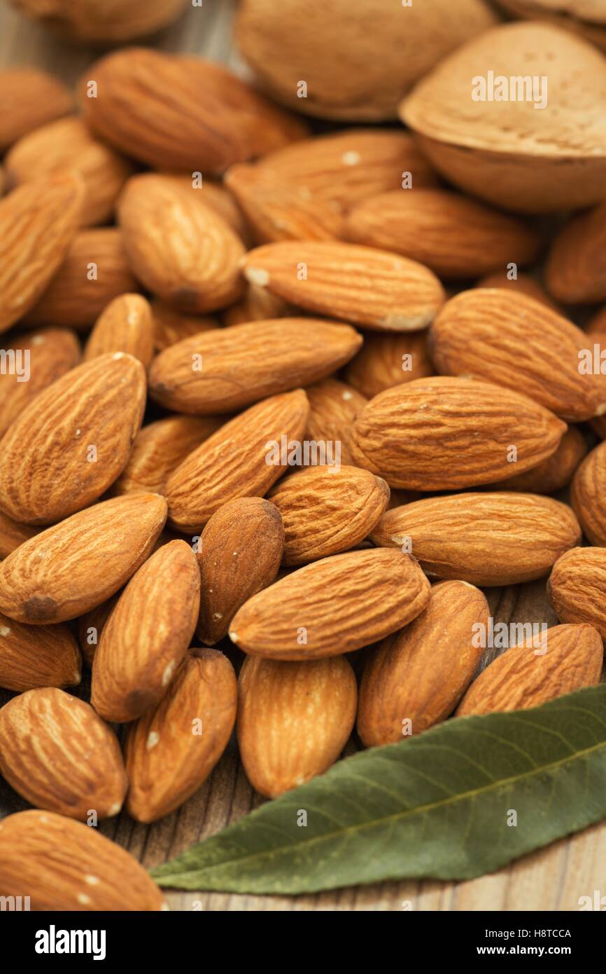 Almonds on brown wooden background. Beneficials for the brain Stock ...