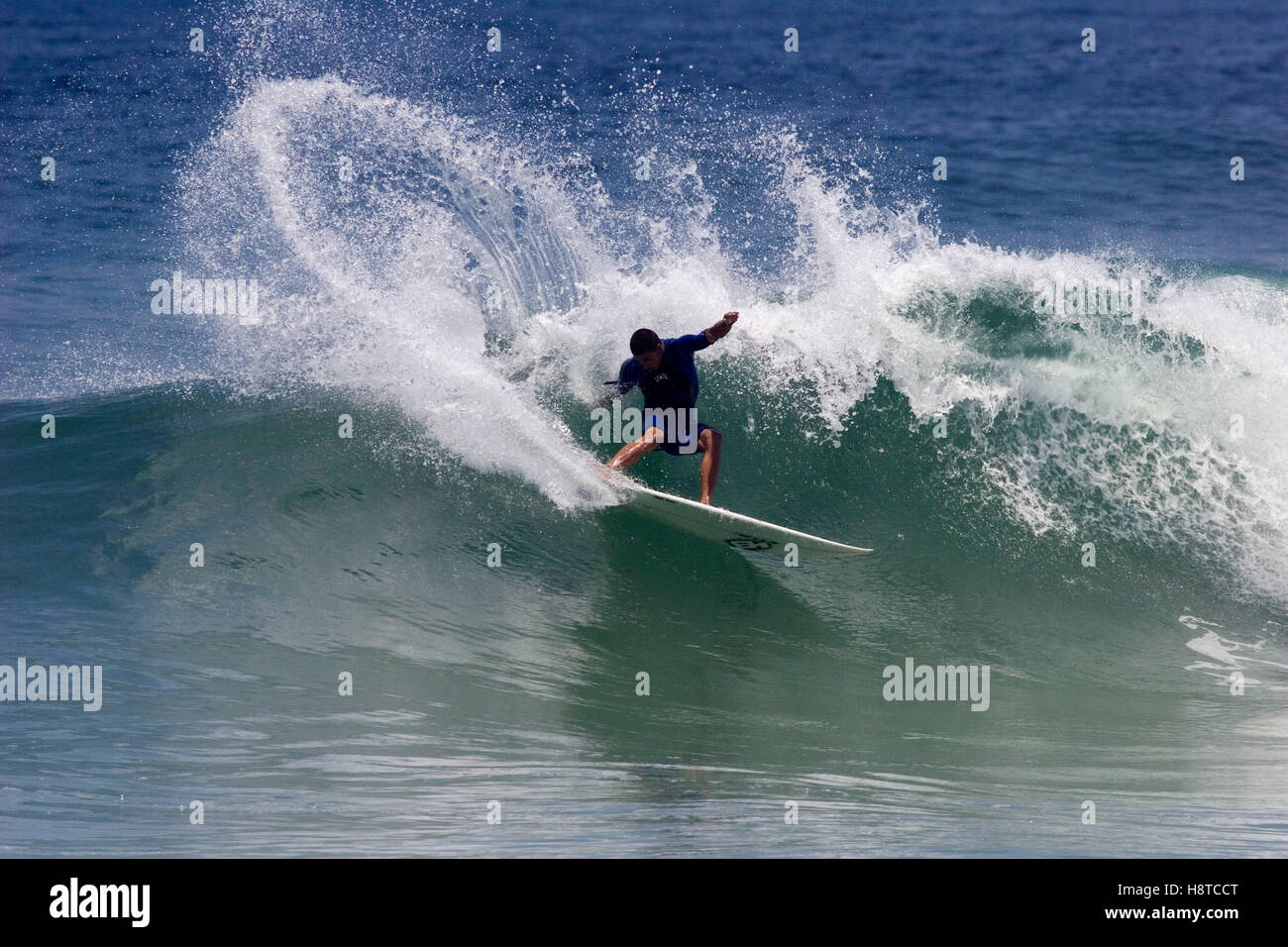 Surfer going radical on a wave Stock Photo - Alamy