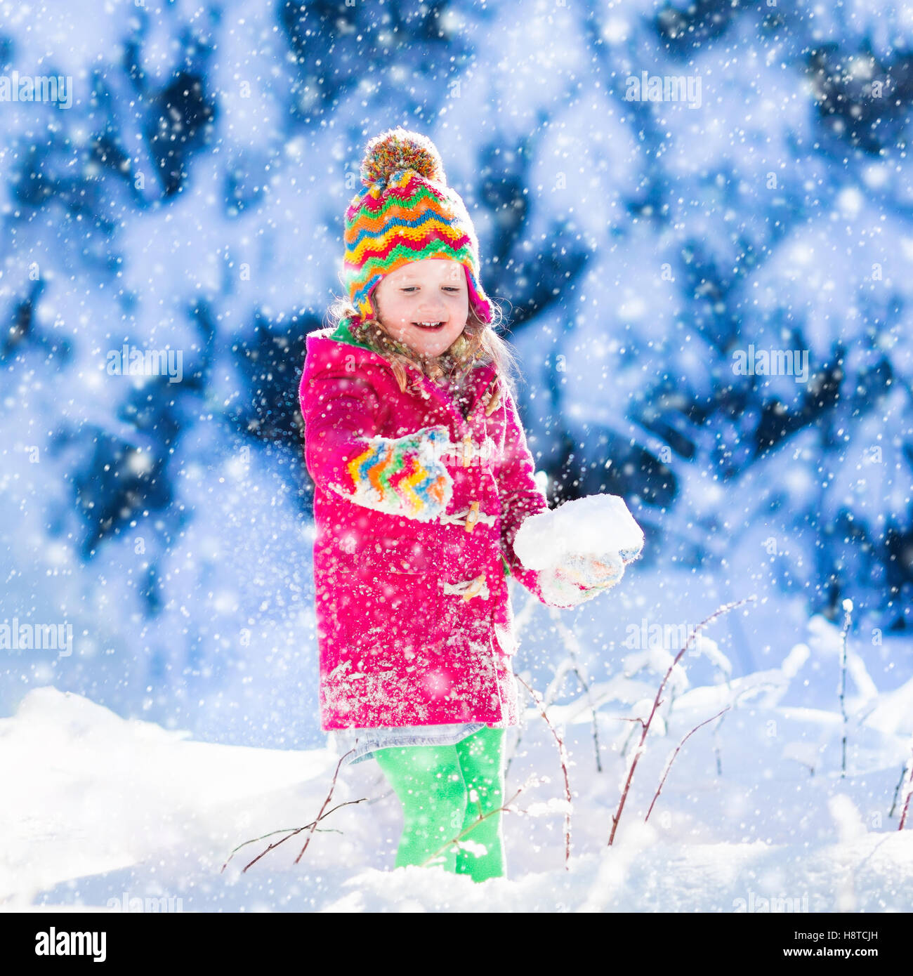 Child running in snowy forest. Toddler kid playing outdoors. Kids play ...