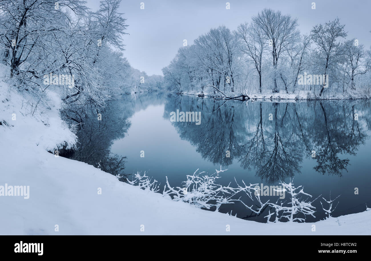 Winter forest on the river at sunset. Colorful landscape with snowy ...