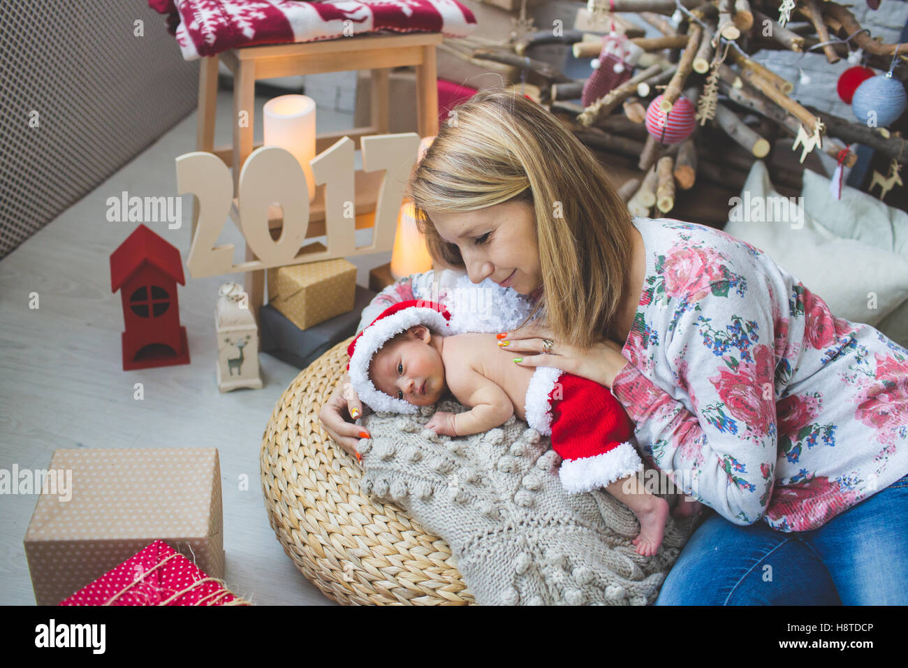 Young woman and her newborn baby in Santa clothes Stock Photo - Alamy