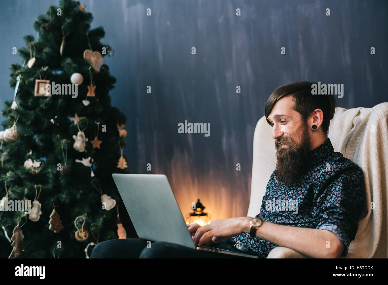 Smiling man using a laptop Stock Photo - Alamy