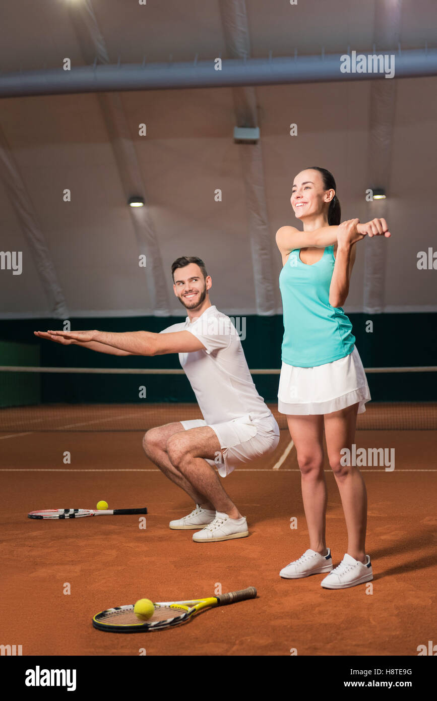 Positive tennis players doing sport exercises Stock Photo - Alamy