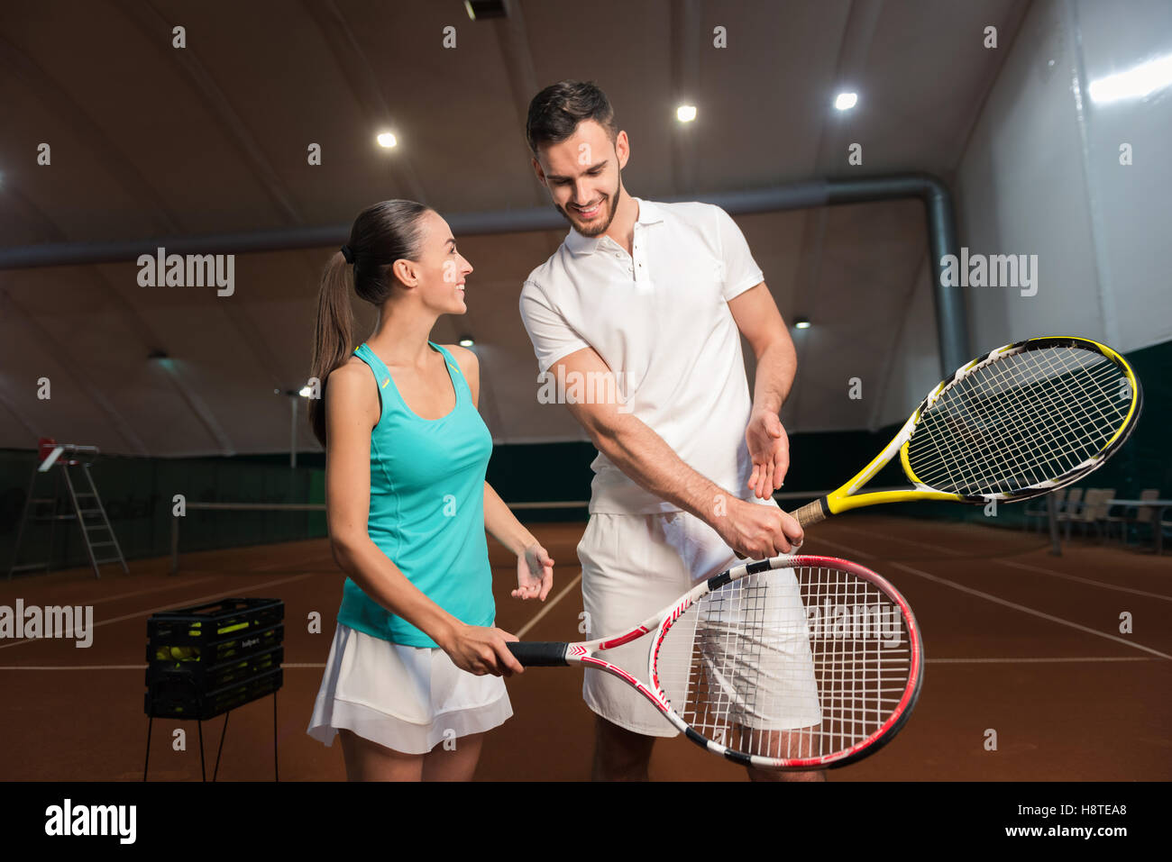 Cheerful friends getting ready to play tennis Stock Photo - Alamy