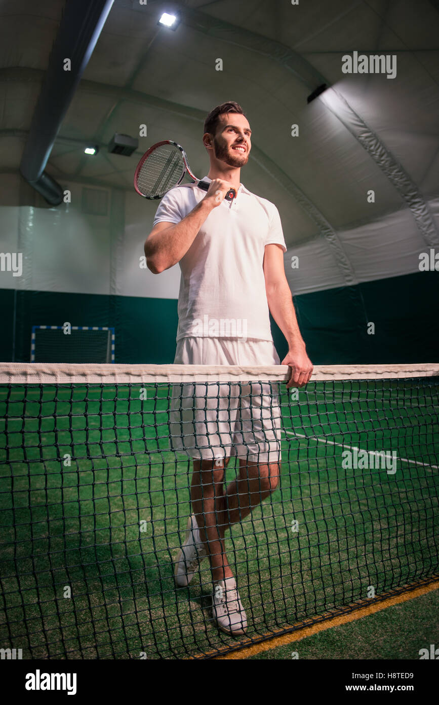 Cheerful professional tennis player training in indoor court Stock ...
