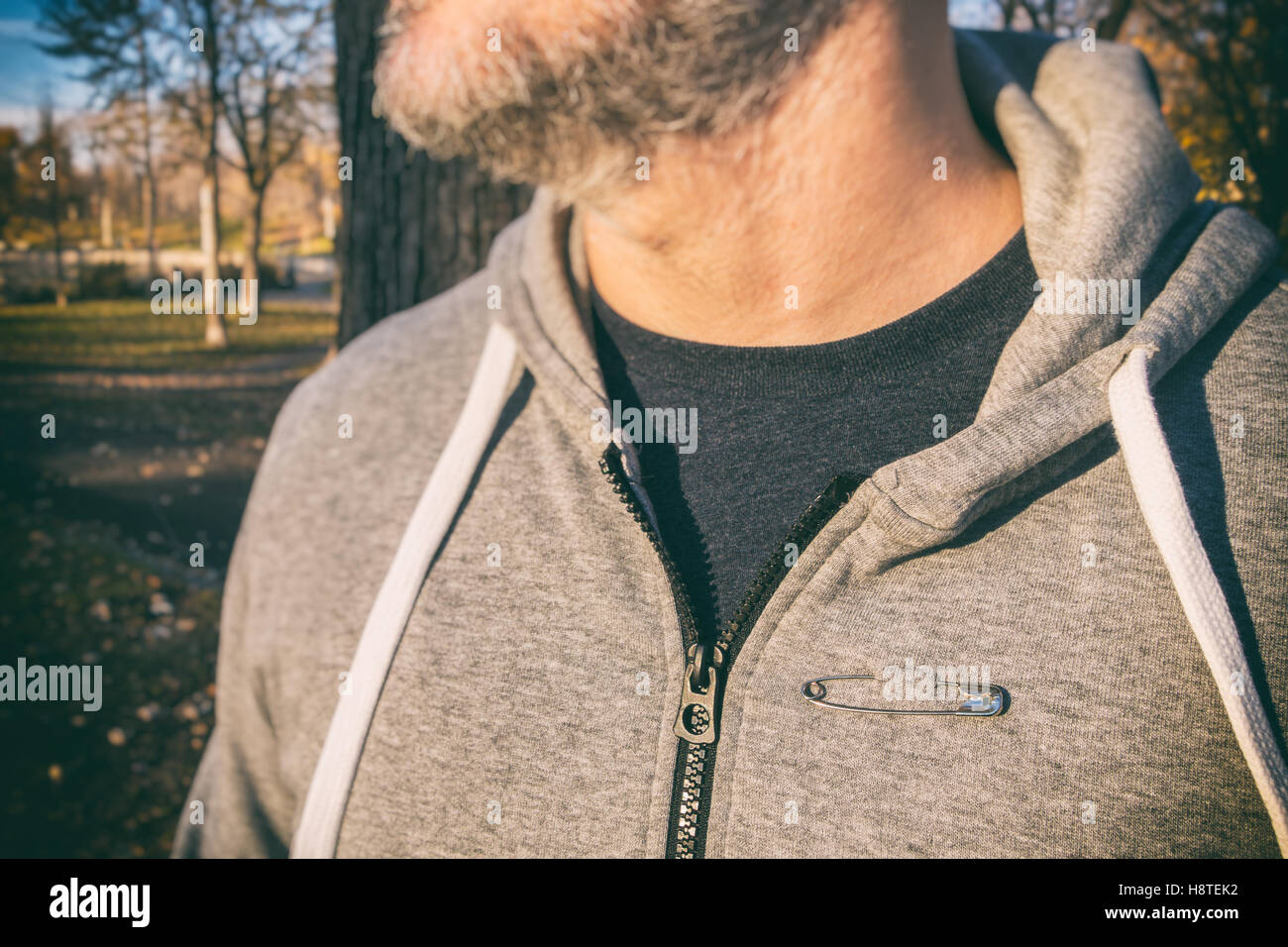 Man wearing a safety pin as a symbol of solidarity Stock Photo - Alamy