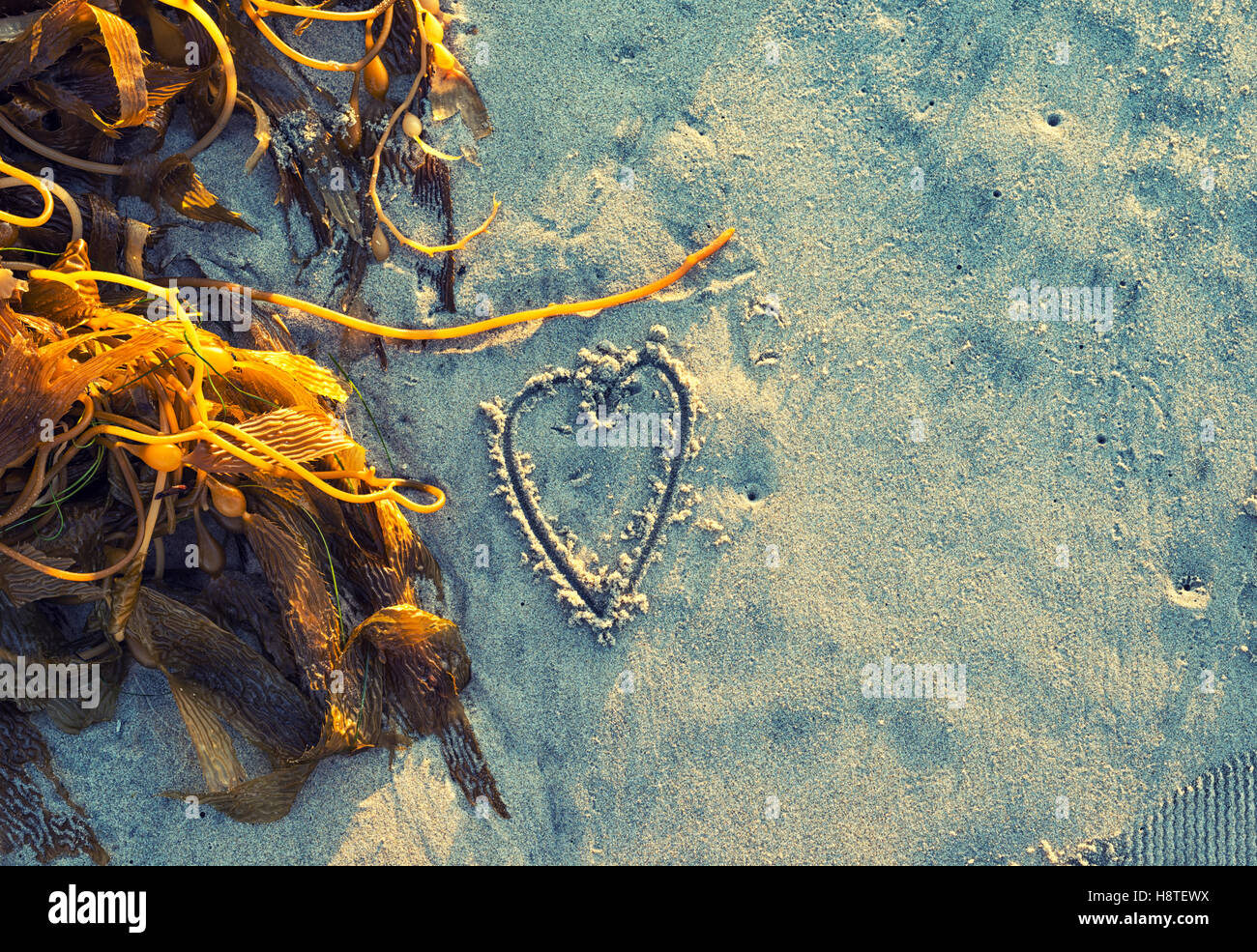 A heart shape carved in the sand Stock Photo - Alamy