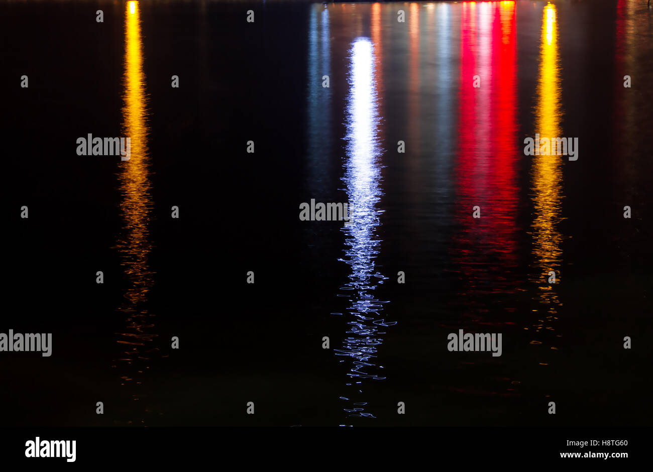 Reflections of colorful lights on the water at night Stock Photo - Alamy