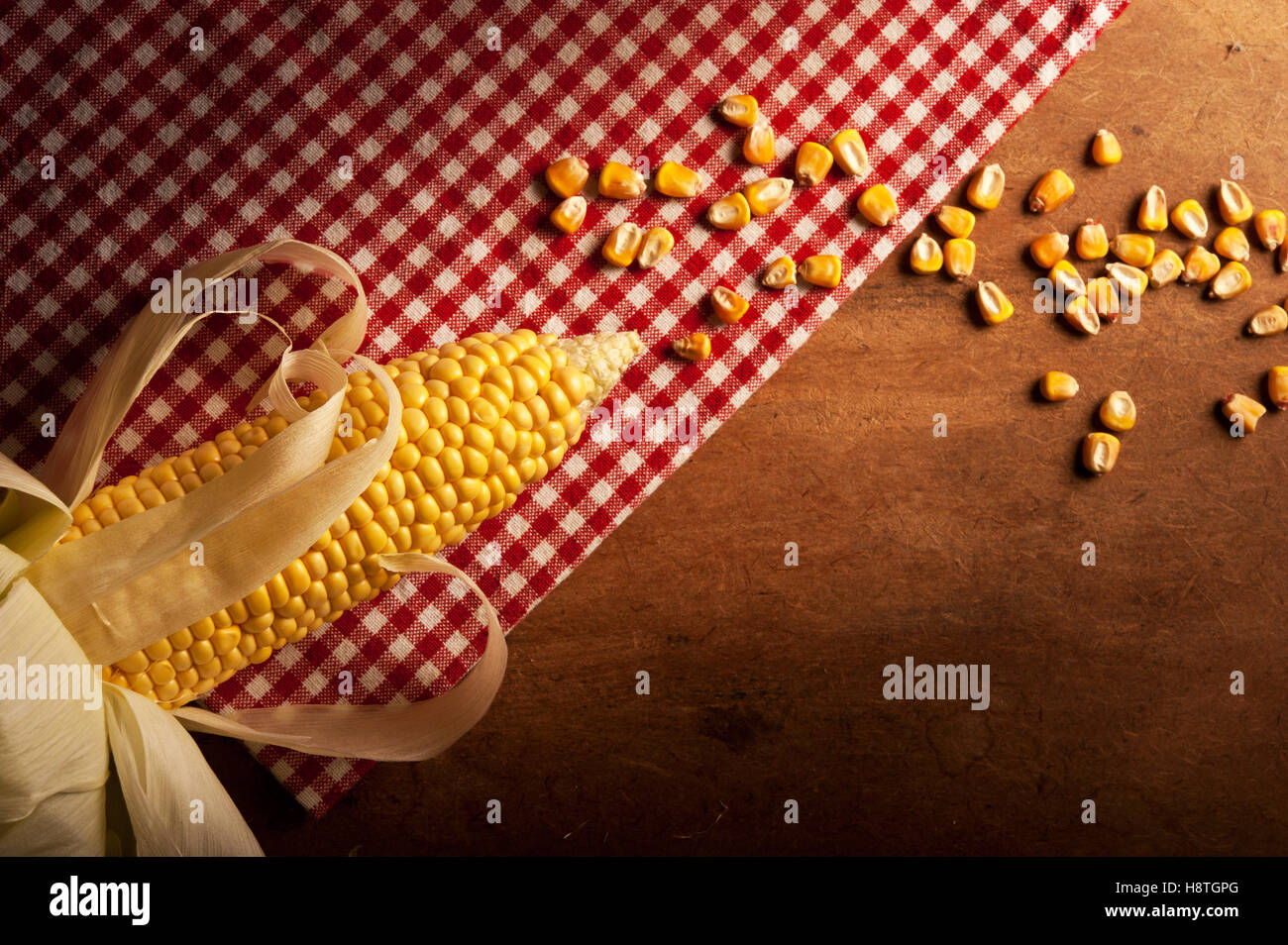 corn maize lying lying on red dish-cloth in rustic style Stock Photo ...