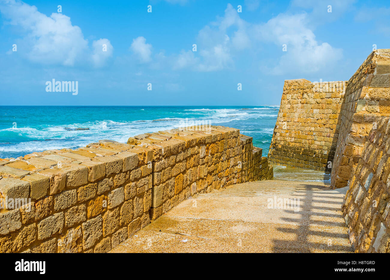 The old sea walls separates the promenade from the coast, Acre, Israel ...
