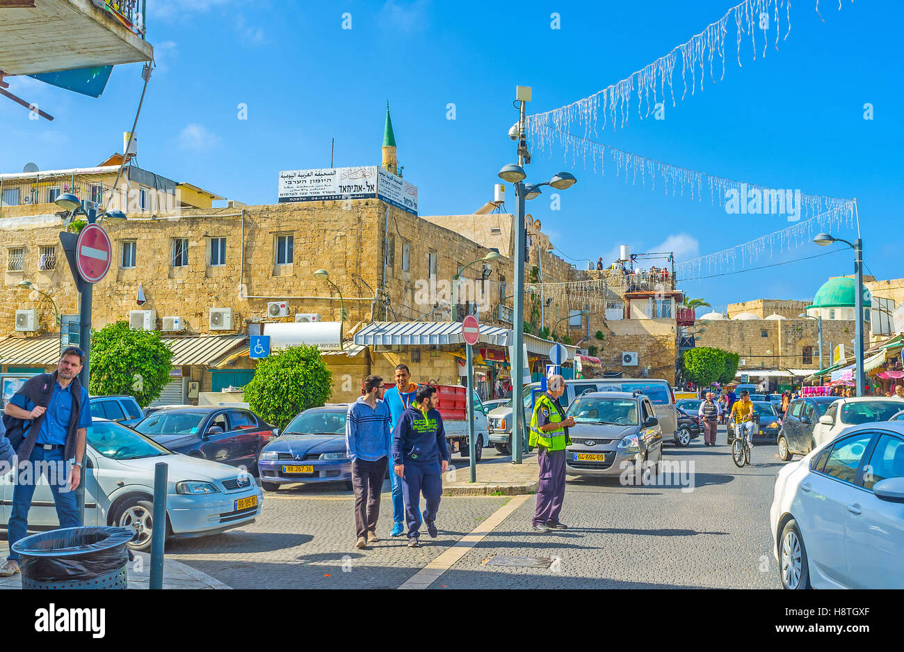 The narrow streets of the old Akko are always full of cars, bikes ...