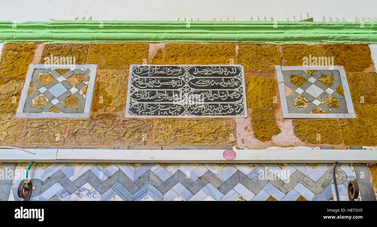 The arabic calligraphy and patterns of the stone tile decorate the ...