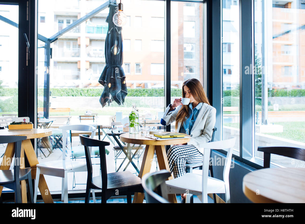 Beautiful Young Woman Drinking Coffee in Coffee Shop Stock Photo - Alamy