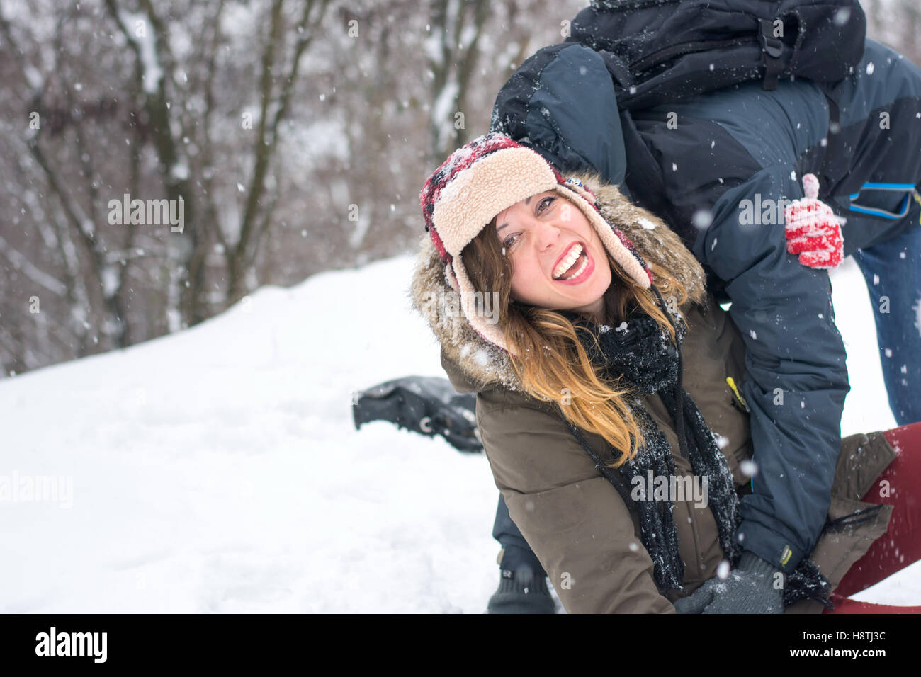 Crazy couple having fun in a snow covered park Stock Photo - Alamy