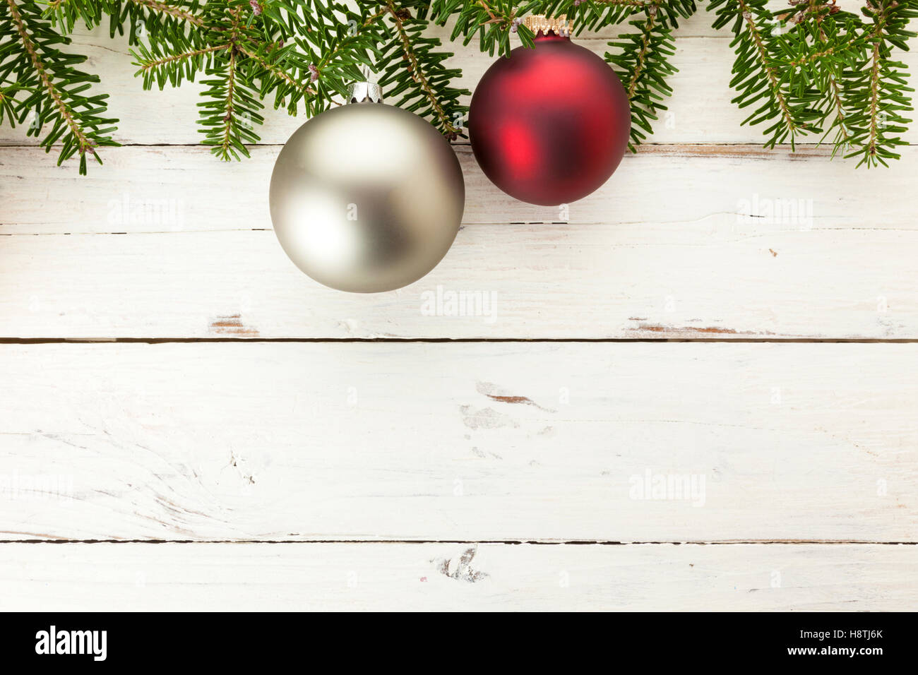 Christmas background with fir twigs and baubles border on white painted ...