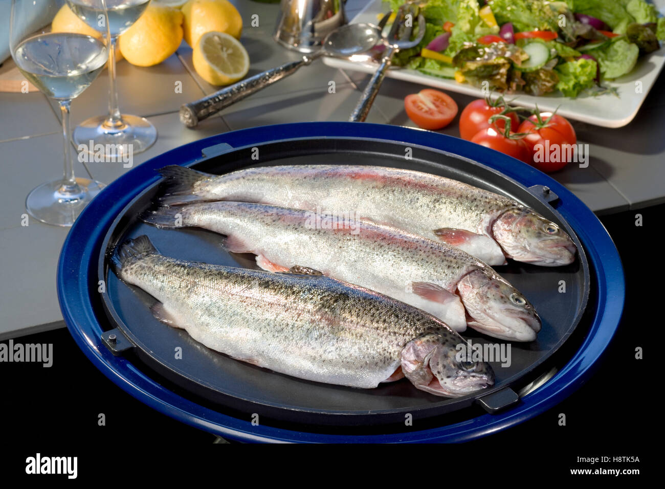 Fresh raw sea bream fish ready to be cooked with herbs, wood background ...