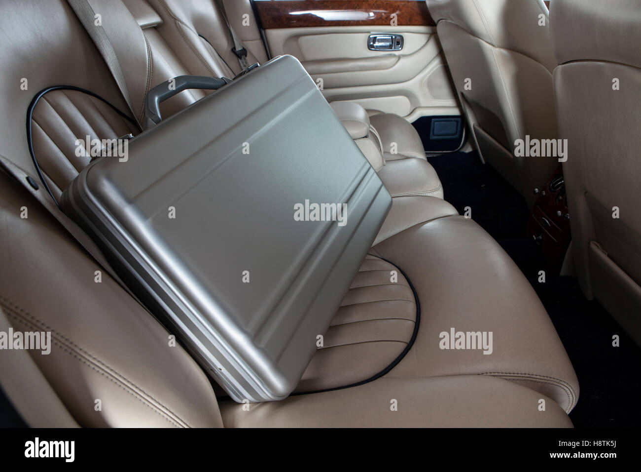 Luxury metal briefcase on the car back seat. Creme leather Stock Photo ...