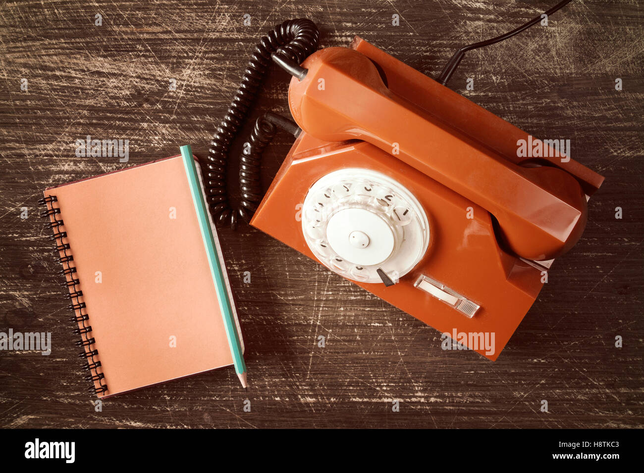Old rotary telephone and spiral notebook on wooden table Stock Photo ...