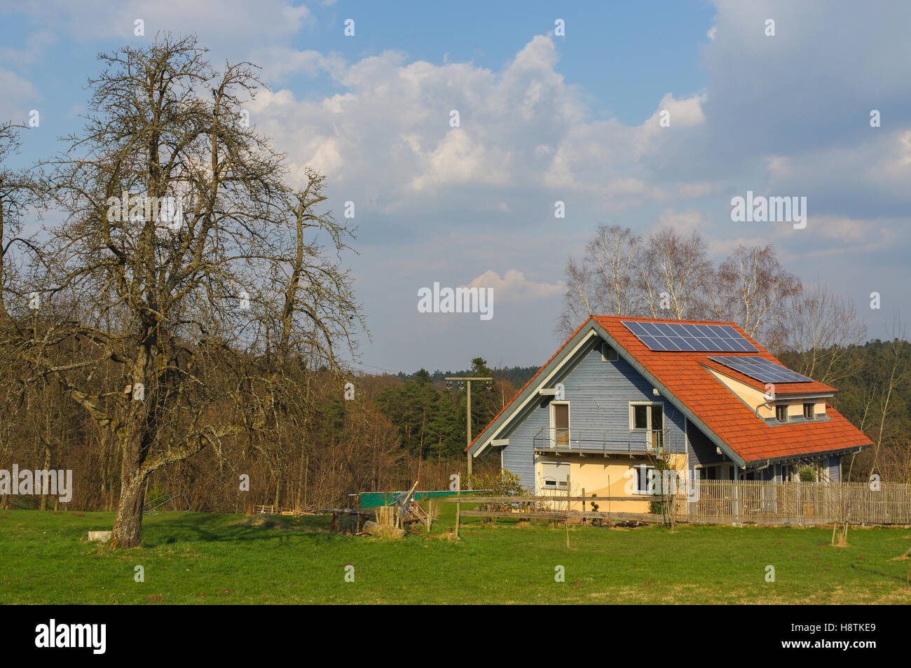 a german rural landscape with wooden house near spring forest. Black ...