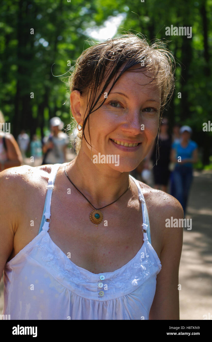 happy young woman gets wet by Fontaine in the Grand Peterhof Palace and ...