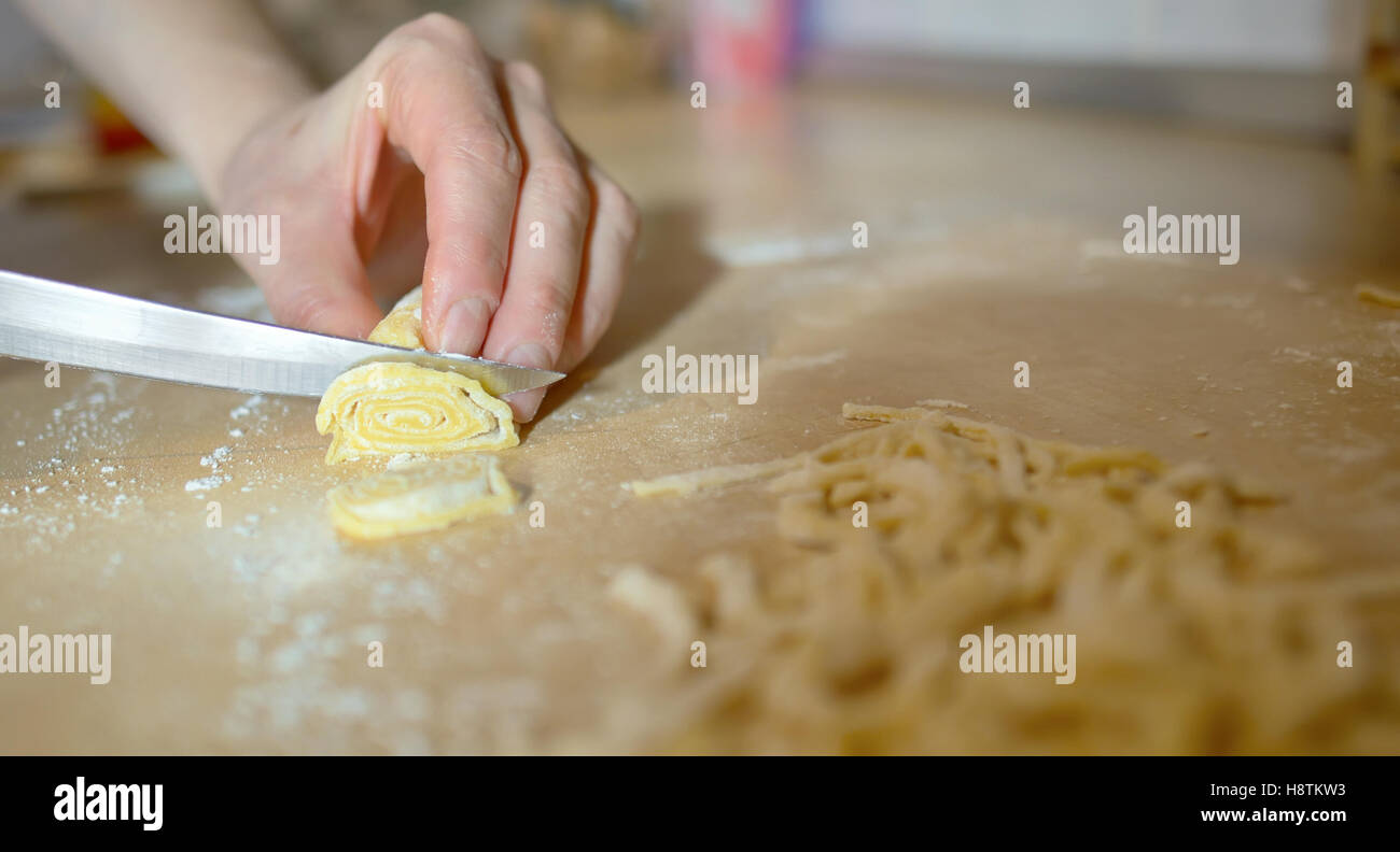 Woman's hands knead dough pasta Stock Photo - Alamy