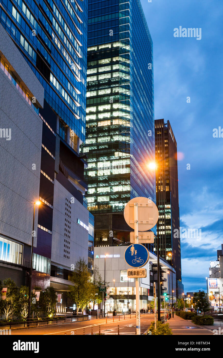 Japan, Osaka, Umeda. View along street, three towering skyscrapers from ...