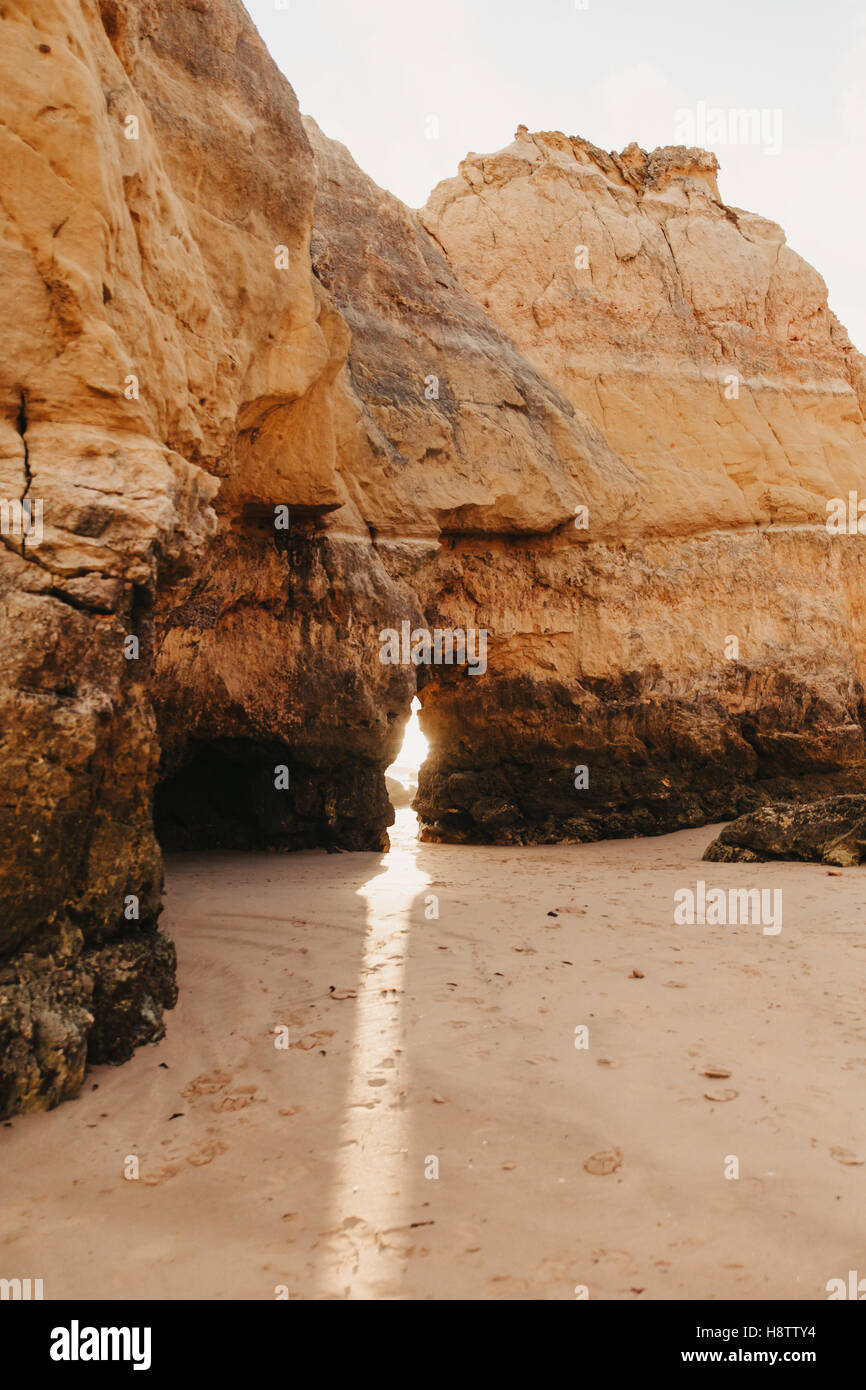 sun shining through rocks on the beach Stock Photo - Alamy