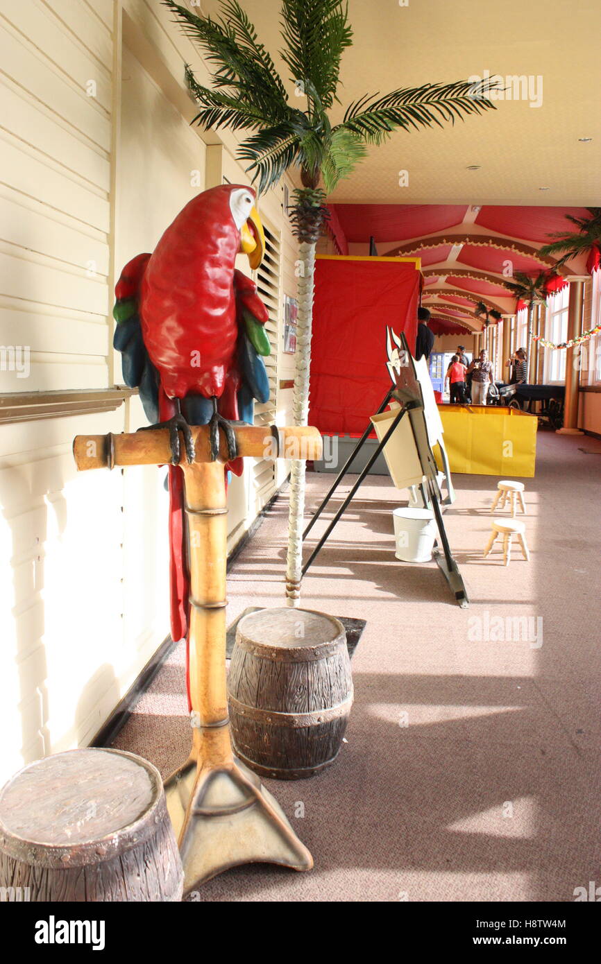 Fake parrot statue prop in a long corridor with a palm tree in the ...