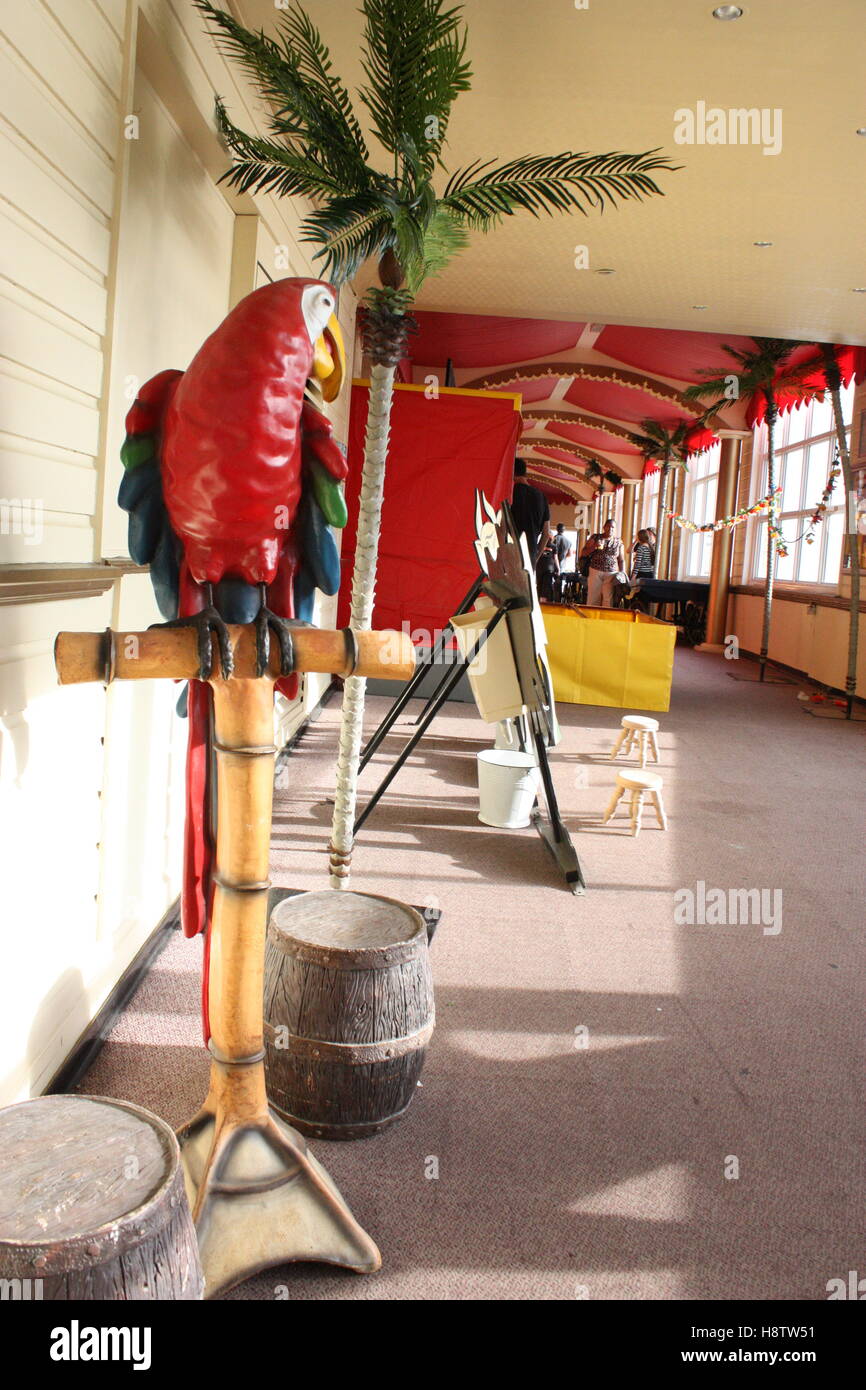 Fake parrot statue prop in a long corridor with a palm tree in the ...