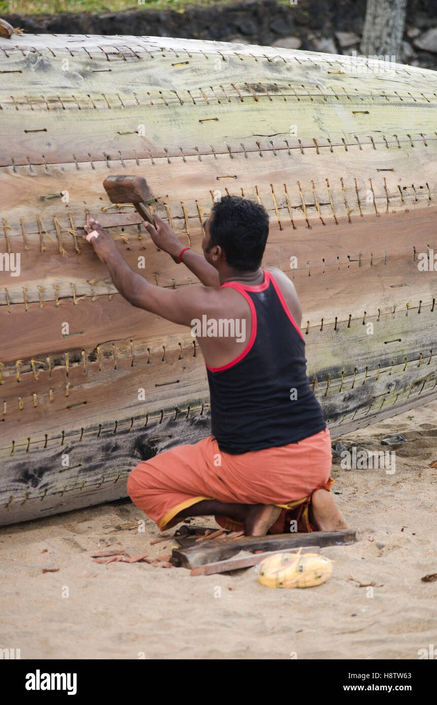 A man fixing a boat in Varkala, Kerala, India Stock Photo - Alamy
