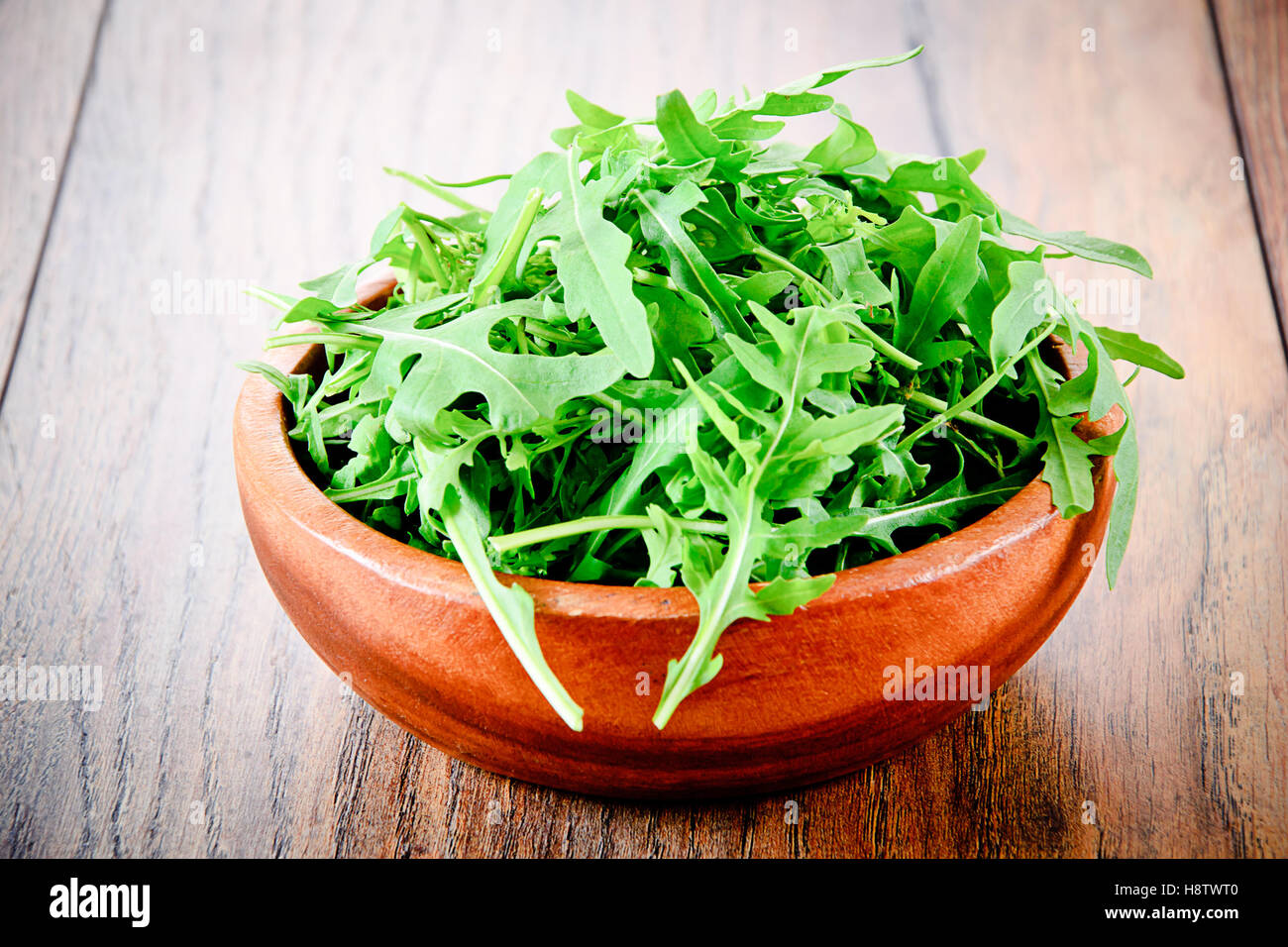 Arugula on Dark Woody Background Stock Photo - Alamy
