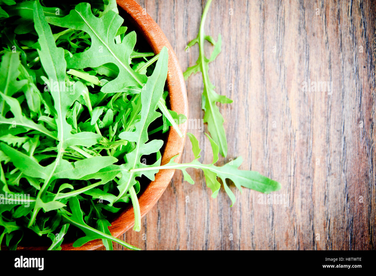 Arugula on Dark Woody Background Stock Photo - Alamy