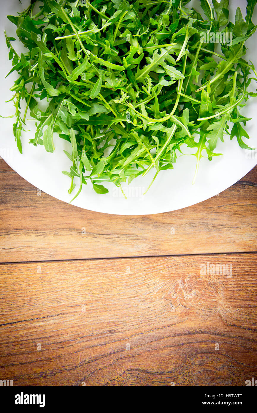 Arugula on Dark Woody Background Stock Photo - Alamy