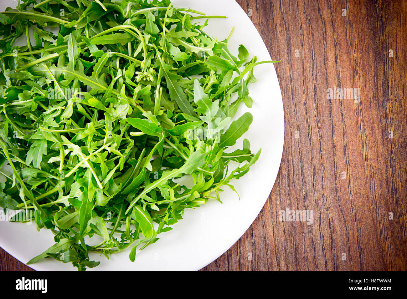 Arugula on Dark Woody Background Stock Photo - Alamy