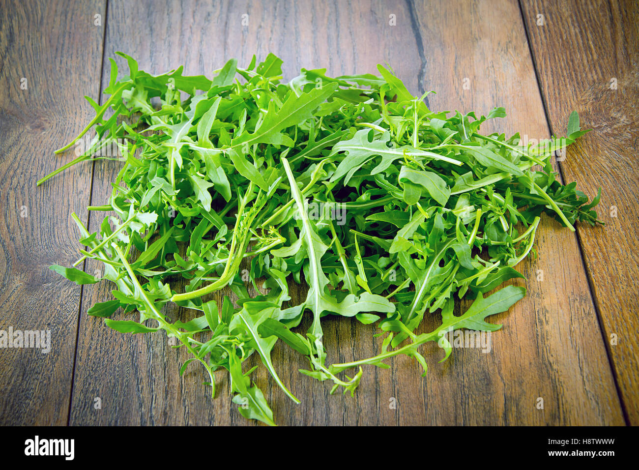 Arugula on Dark Woody Background Stock Photo - Alamy