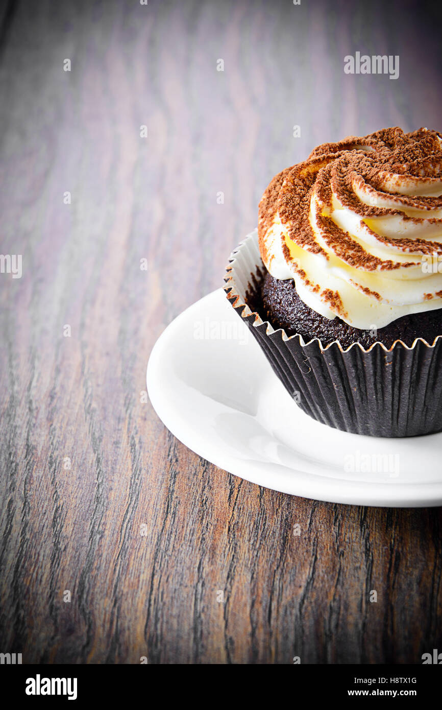 Cake with Cream, Cupcake on Woody Background Stock Photo - Alamy