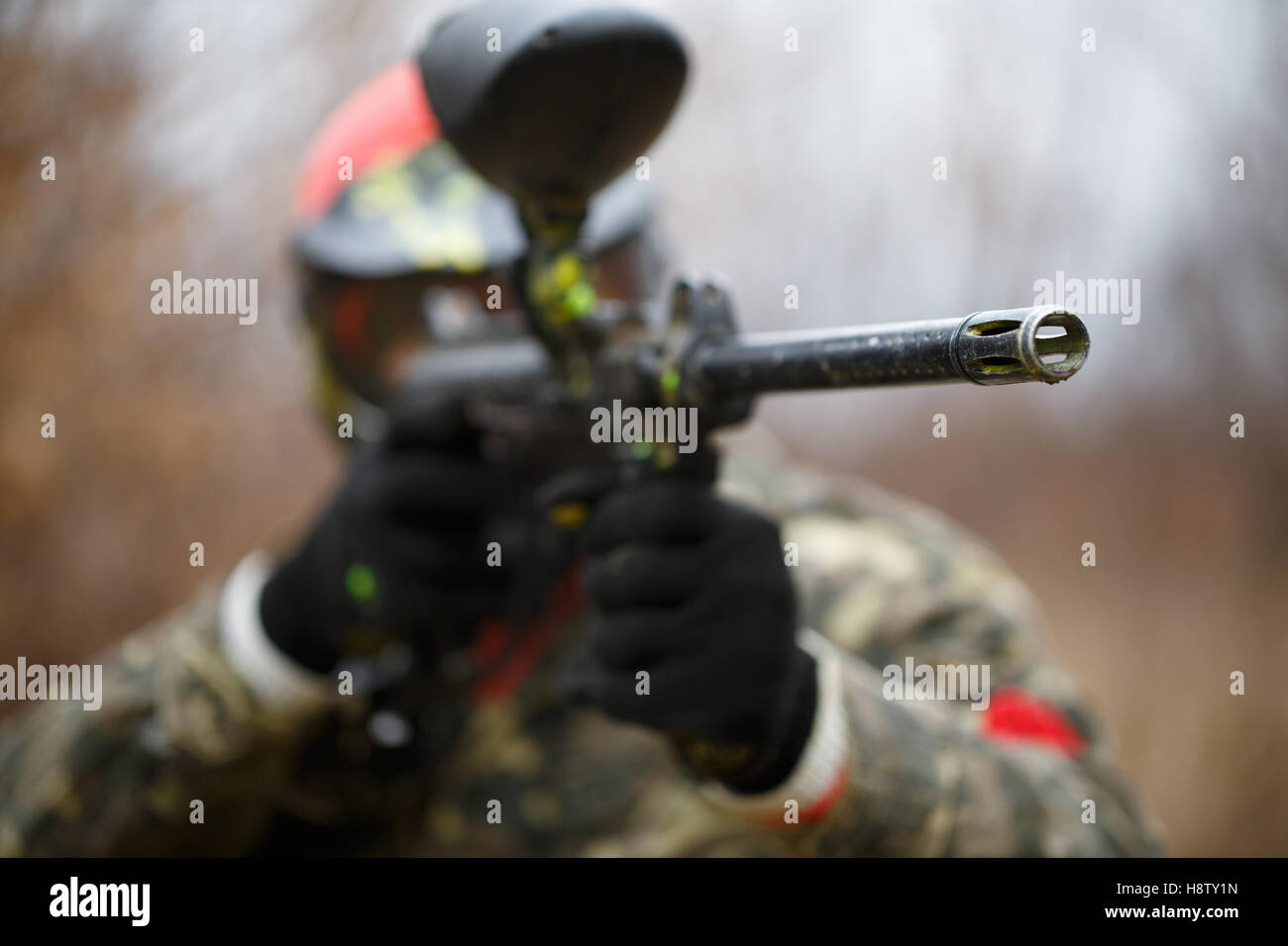 Paintball sport player wearing protective mask and aiming gun Stock ...