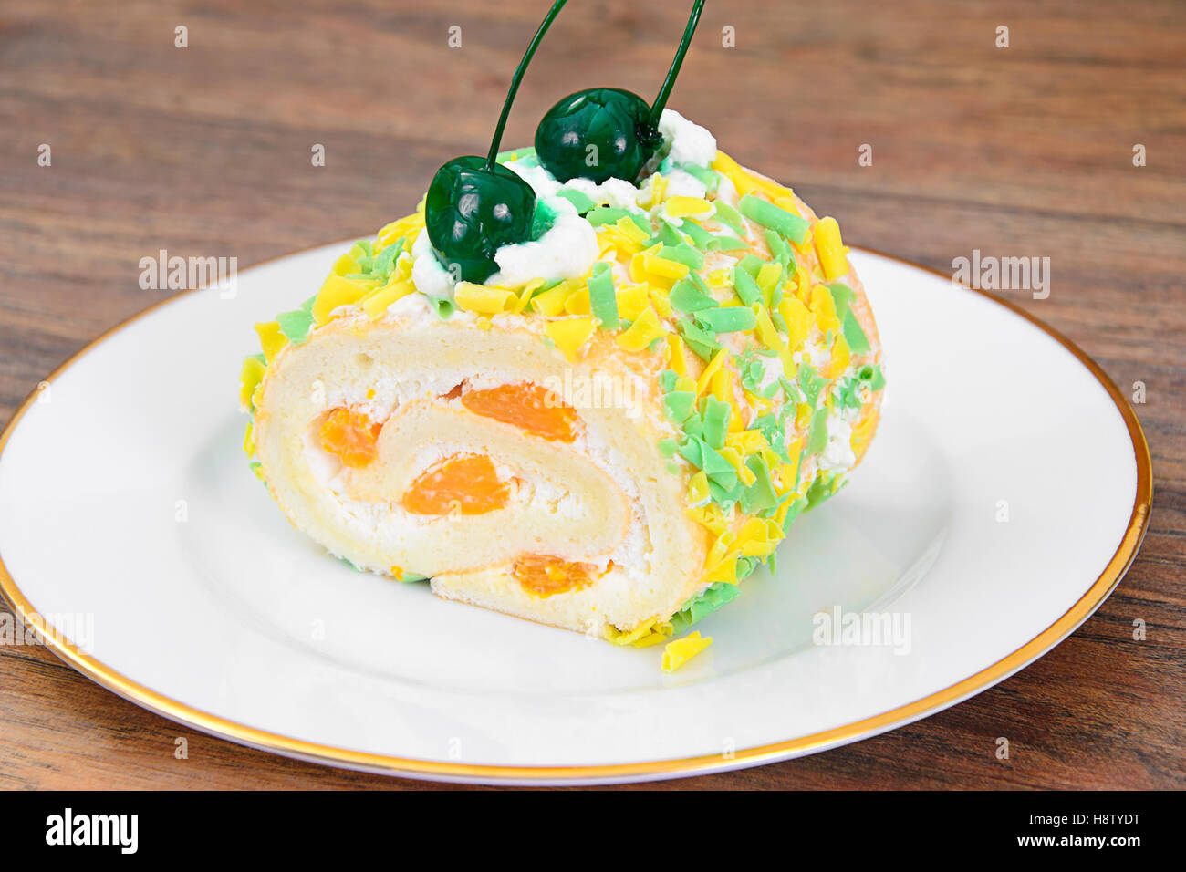 Sponge Roulade with Cream, Mandarin and Cherry Stock Photo - Alamy