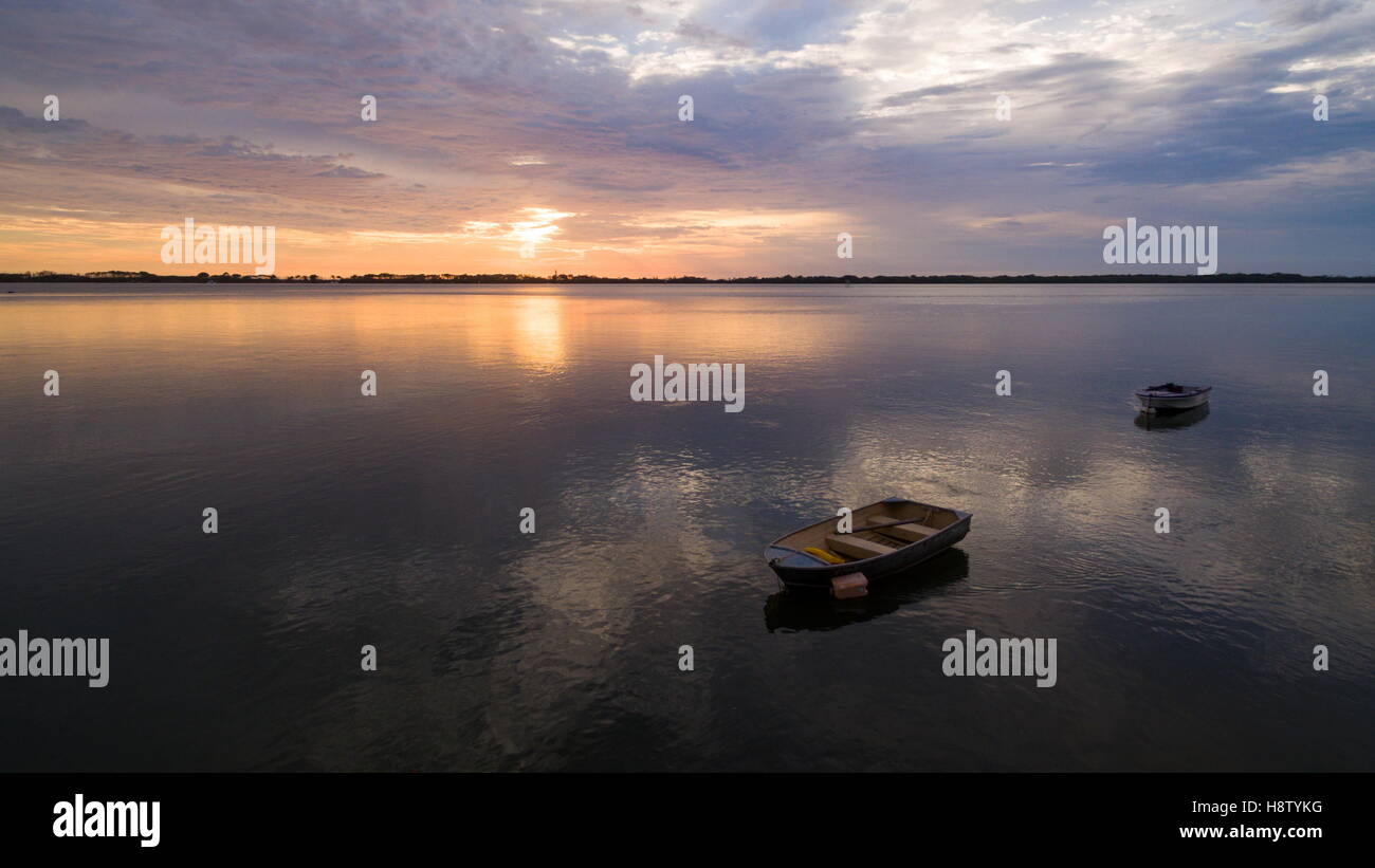 Aerial image as sunrise breaks over two small fishing boats at their ...