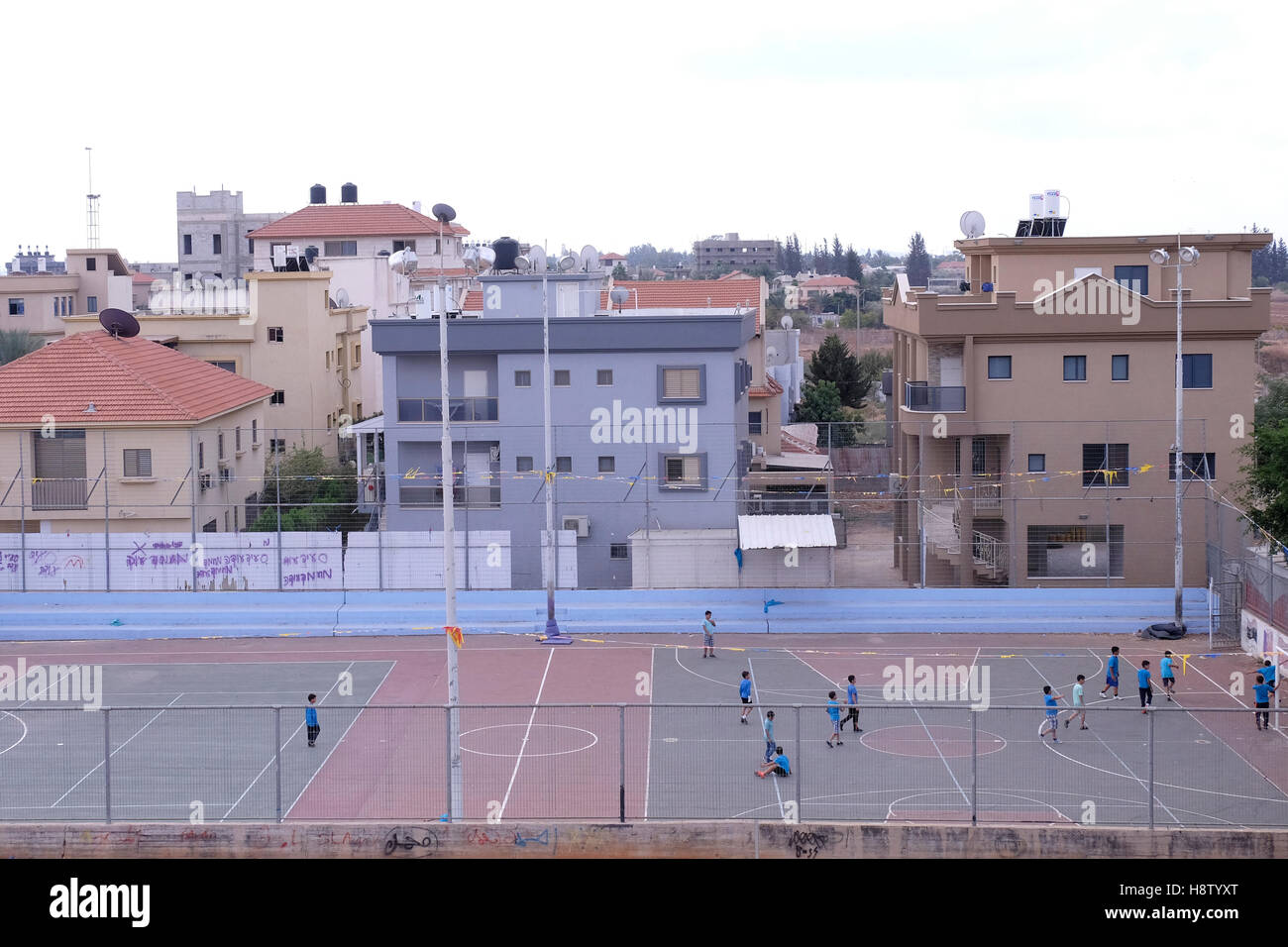 Young Israeli Arab children playing football in a playground in the ...